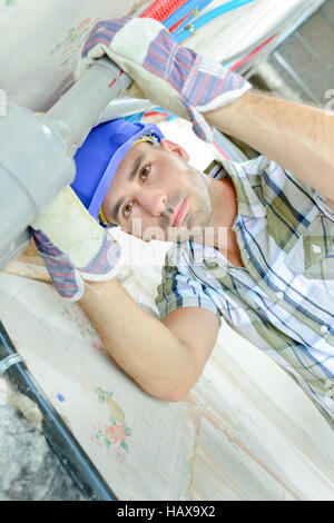 Man fitting pvc pipe Stock Photo - Alamy