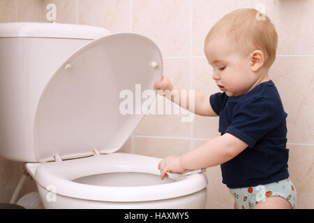 little boy looks in the toilet Stock Photo - Alamy