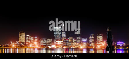 Businesswoman viewing night glowing city Stock Photo - Alamy