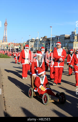 Blackpool, UK. 4th Dec, 2016. Four friends in Christmas outfits pose ...
