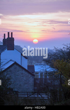 Country cottage in a misty Welsh valley wooded landscape in October ...