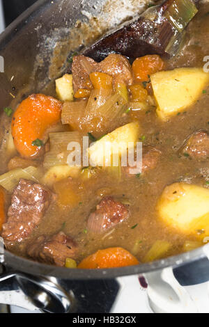 Delicious simmering brown gravy on a stovetop on Thanksgiving day in a ...