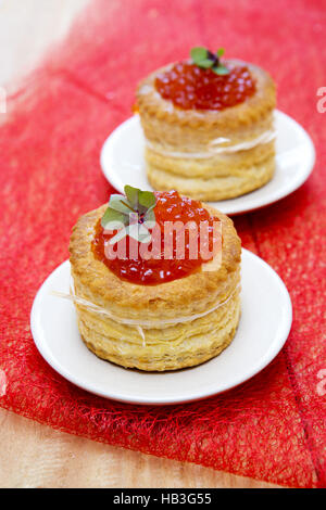 Plate with salmon tartlets on table Stock Photo - Alamy