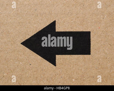 Black arrow on cardboard Stock Photo - Alamy