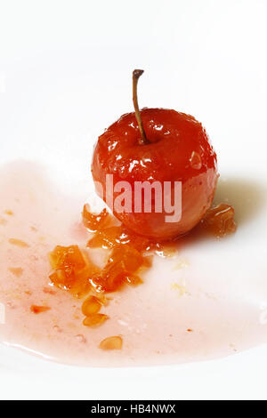 Red apple in rose syrup with small pieces of zucchini and with anise ...