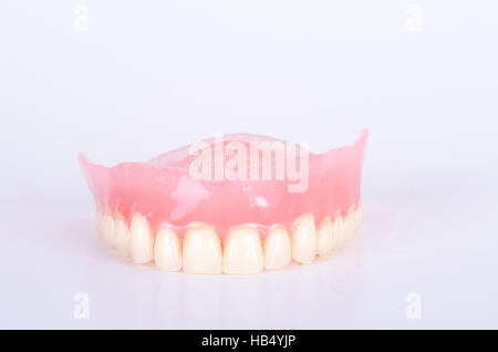 Photo of false teeth on white background Stock Photo - Alamy