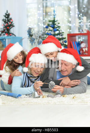 Happy caucasian family in santa hats smiling on tablet video call ...