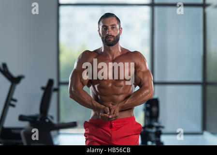 Young Italian Man Standing Strong In The Gym And Flexing Muscles ...