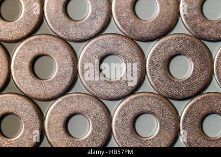 Joiner's accessories. Stacks of metal screw washers and nuts isolated ...