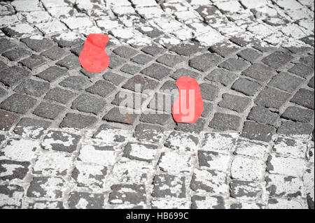 Red footsteps in town Stock Photo - Alamy
