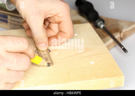 Carpenter writing a mark on a wood piece Stock Photo - Alamy