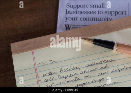 A small lined yellow legal pad and ball-point pen Stock Photo - Alamy