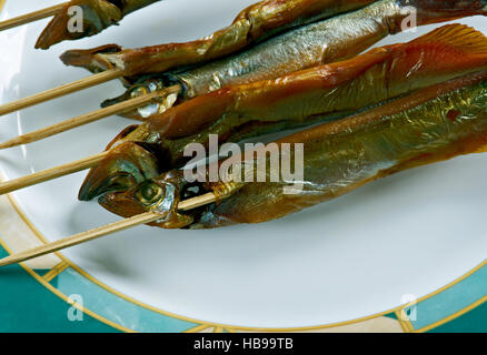 Steckerlfisch (grilled fish on a stick) - traditional meal seen on ...