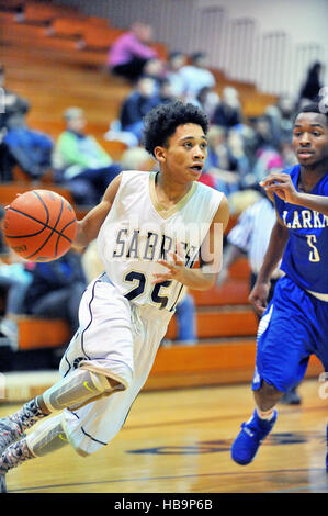 Basketball player driving toward the basket and along the baseline and ...