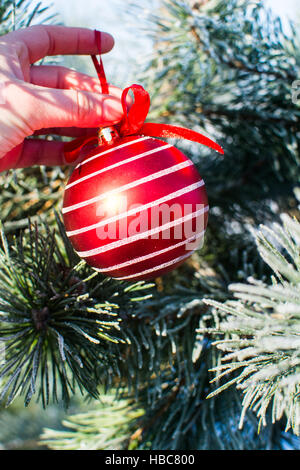 Gold striped Christmas toy in the form of a Christmas tree, a roll of ...