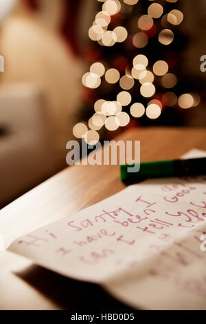 Santa Claus writing a list and young man sitting and talking in a cafe ...