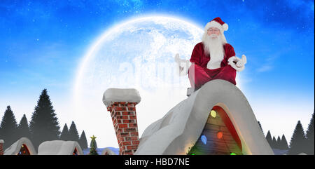 Composite image of santa claus sits and meditates Stock Photo - Alamy