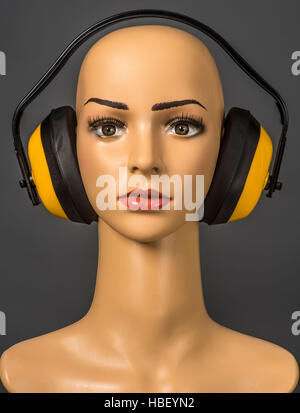 Mannequin wearing yellow ear defenders for hearing protection Stock ...