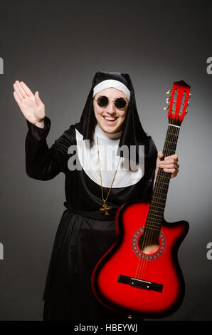 Funny nun with red guitar playing Stock Photo - Alamy