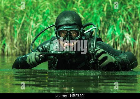 U.S. Navy SEAL combat diver prepares for HALO jump operations from a ...