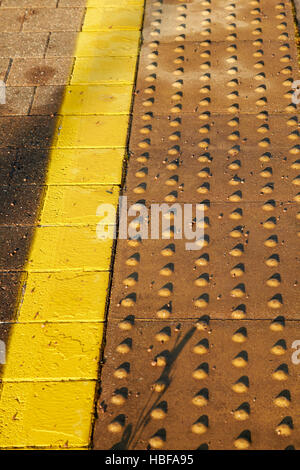 yellow lines and textured area of edge of train platform in the uk ...