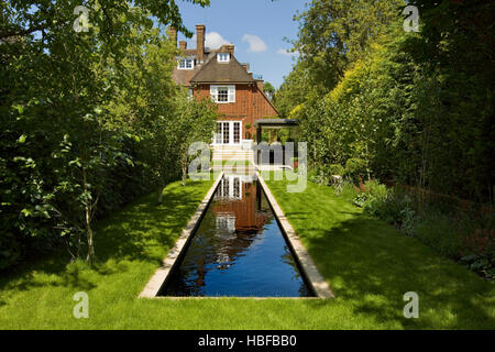 A contemporary water feature or rill in a large English country garden ...