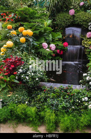 Mirror Stream fountain, park with flowers and green trees in the ...