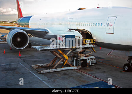 Loading of airplane at airport. Cargo container in blurred motion Stock ...