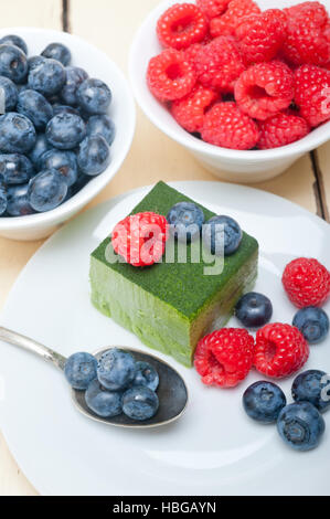 green tea matcha mousse cake with raspberries and blueberries on top ...