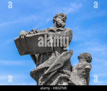 Statue of an old teacher with mutilated hand and his student Stock ...