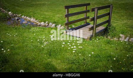 Small wood bridge in a garden with reflection Stock Photo - Alamy
