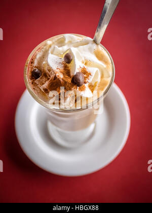 Latte macchiato with whipped cream, serving silver spoon Stock Photo ...