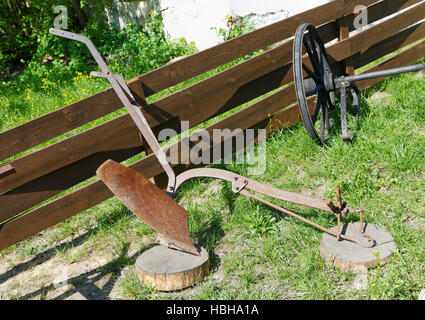 iron plow at the wooden fence summer day Stock Photo - Alamy