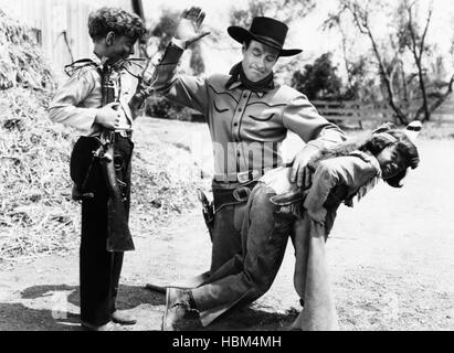 CHEYENNE WILDCAT, Bill Elliott, spanking Robert Blake, 1944 Stock Photo ...