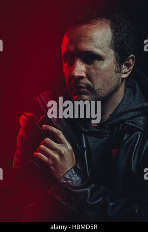 Robber with gun over red background Stock Photo - Alamy