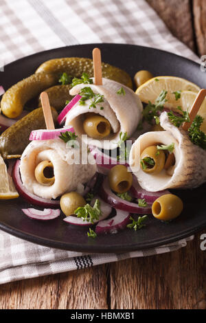 Rolls of herring fillet with olives Stock Photo - Alamy