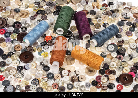 Composition with threads and buttons on white background Stock Photo ...
