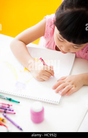 Portrait of cute girl drawing picture at home Stock Photo - Alamy