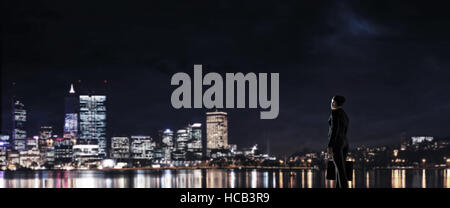 Businesswoman viewing night glowing city Stock Photo - Alamy