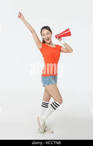 Woman standing with megaphone Stock Photo - Alamy