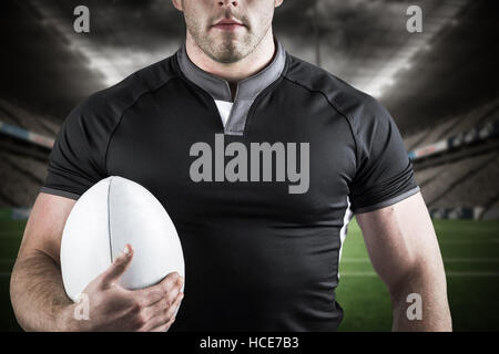 Composite image of tough rugby player looking at camera Stock Photo - Alamy