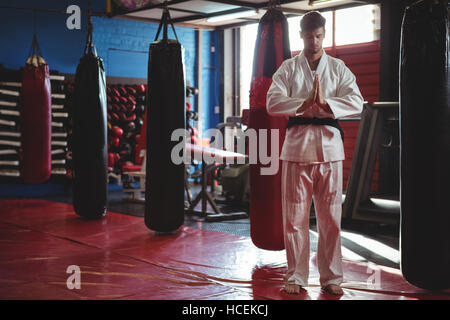 Karate player in prayer pose Stock Photo: 126886230 - Alamy
