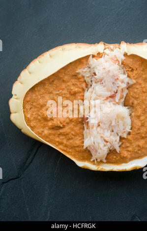 Dressed crab in the shell shot on a slate back ground Stock Photo - Alamy