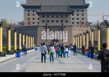 Tourists at Xian East Gate drawbridge entrance to city walls, Shaanxi ...