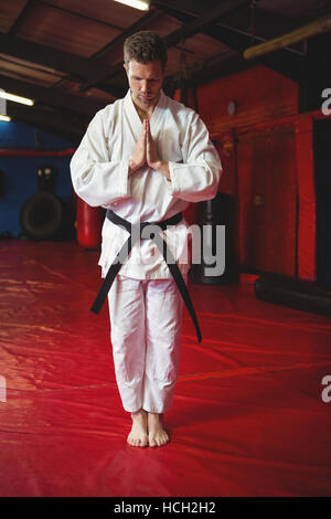 Karate player in prayer pose Stock Photo - Alamy