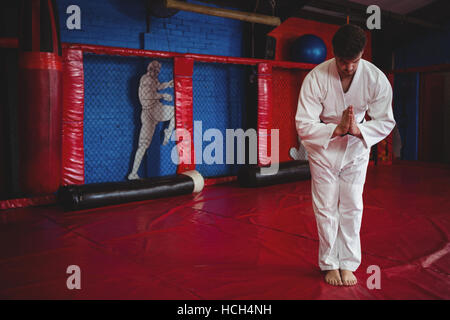 Karate player in prayer pose Stock Photo - Alamy