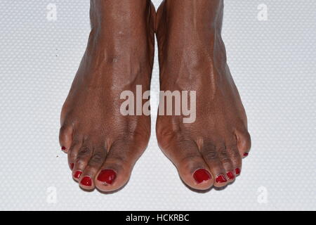 Black female feet with toes curled upwards on a white background Stock ...