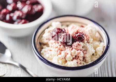 Breakfast from cottage cheese with cherry jam on a white wooden ...