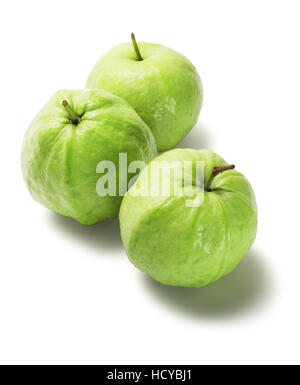 Three ripe guava fruits with green skin and vibrant pink flesh on ...