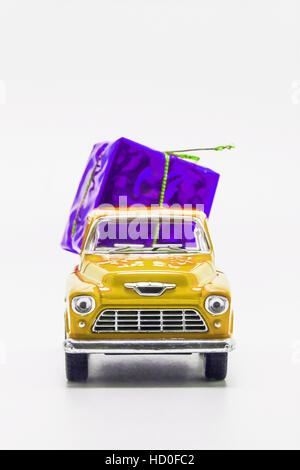 yellow retro car pickup violet gift box isolated Stock Photo - Alamy